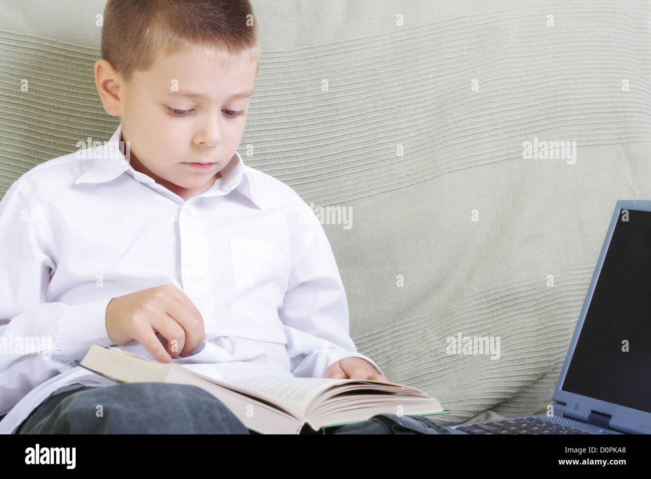 Boy reading book Stock Photo - Alamy