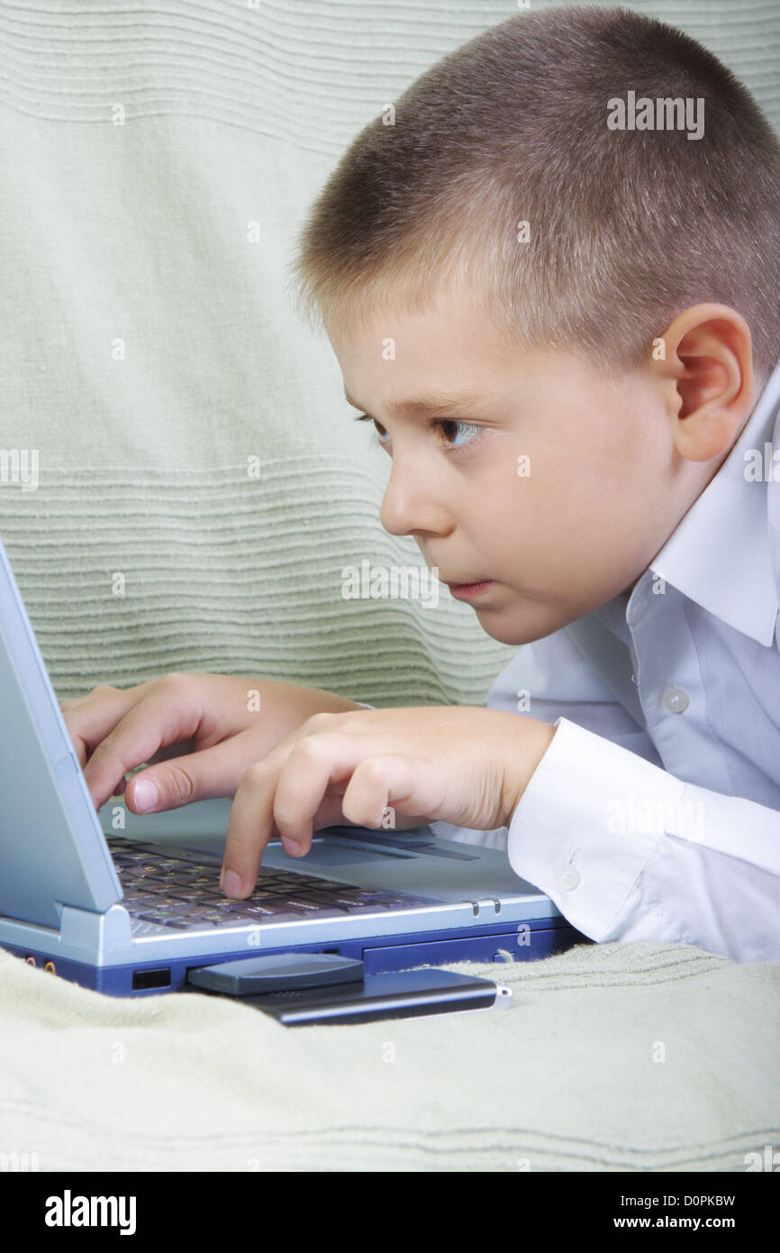 Boy working on laptop Stock Photo - Alamy