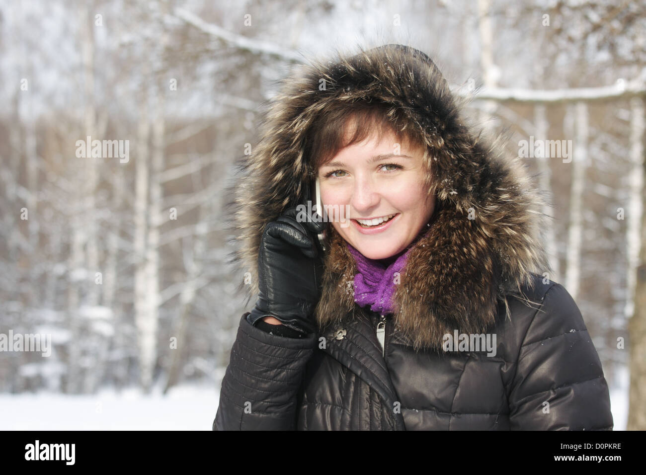 Positive woman on cellphone in frosty day Stock Photo - Alamy