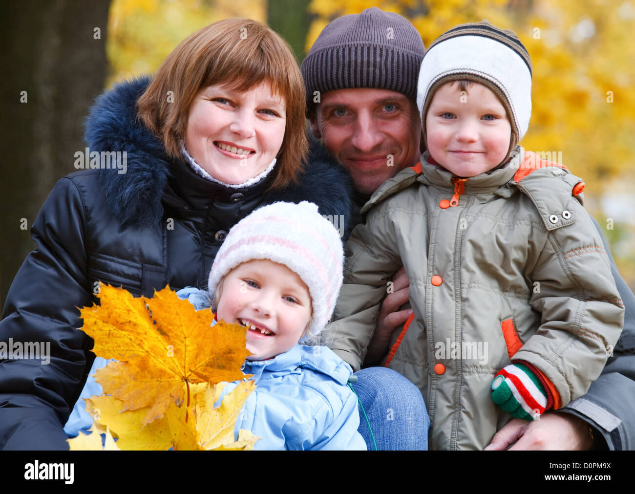 Family in autumn park Stock Photo - Alamy
