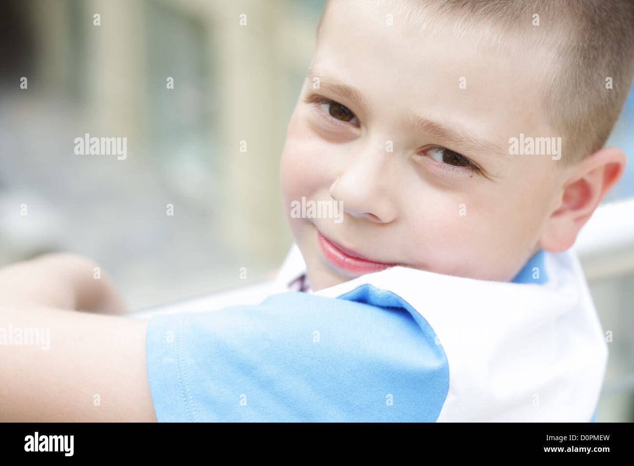 Boy looking over shoulder Stock Photo - Alamy
