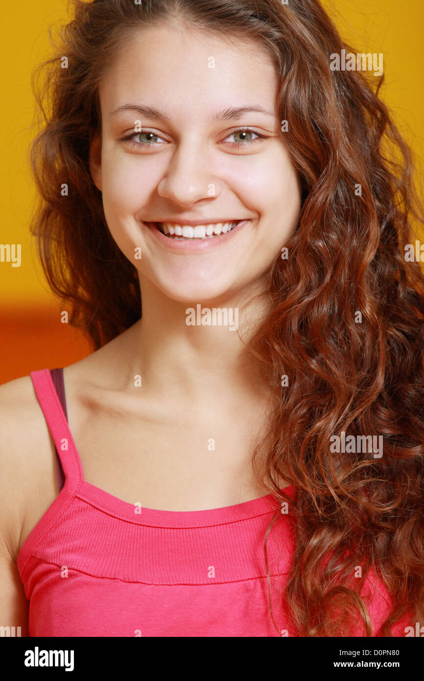 Toothy smiling girl in red Stock Photo - Alamy