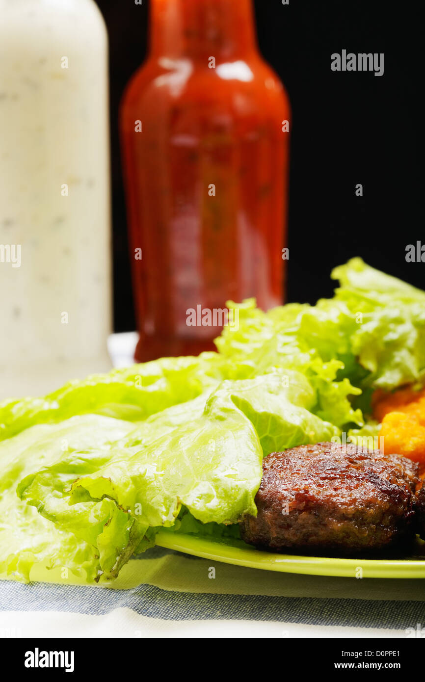 Beef cutlets meal with sauces Stock Photo - Alamy