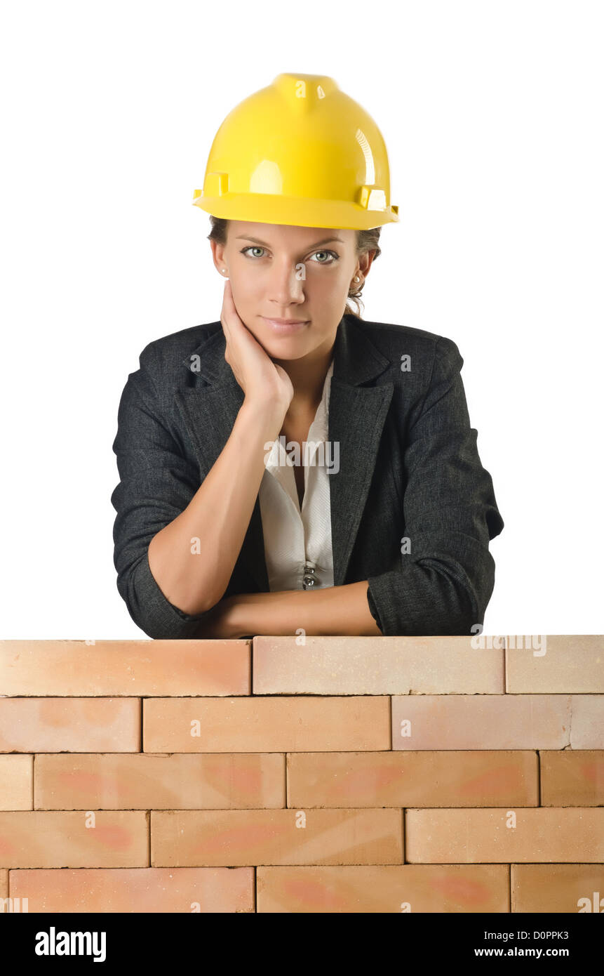 Young female builder near brick wall Stock Photo - Alamy