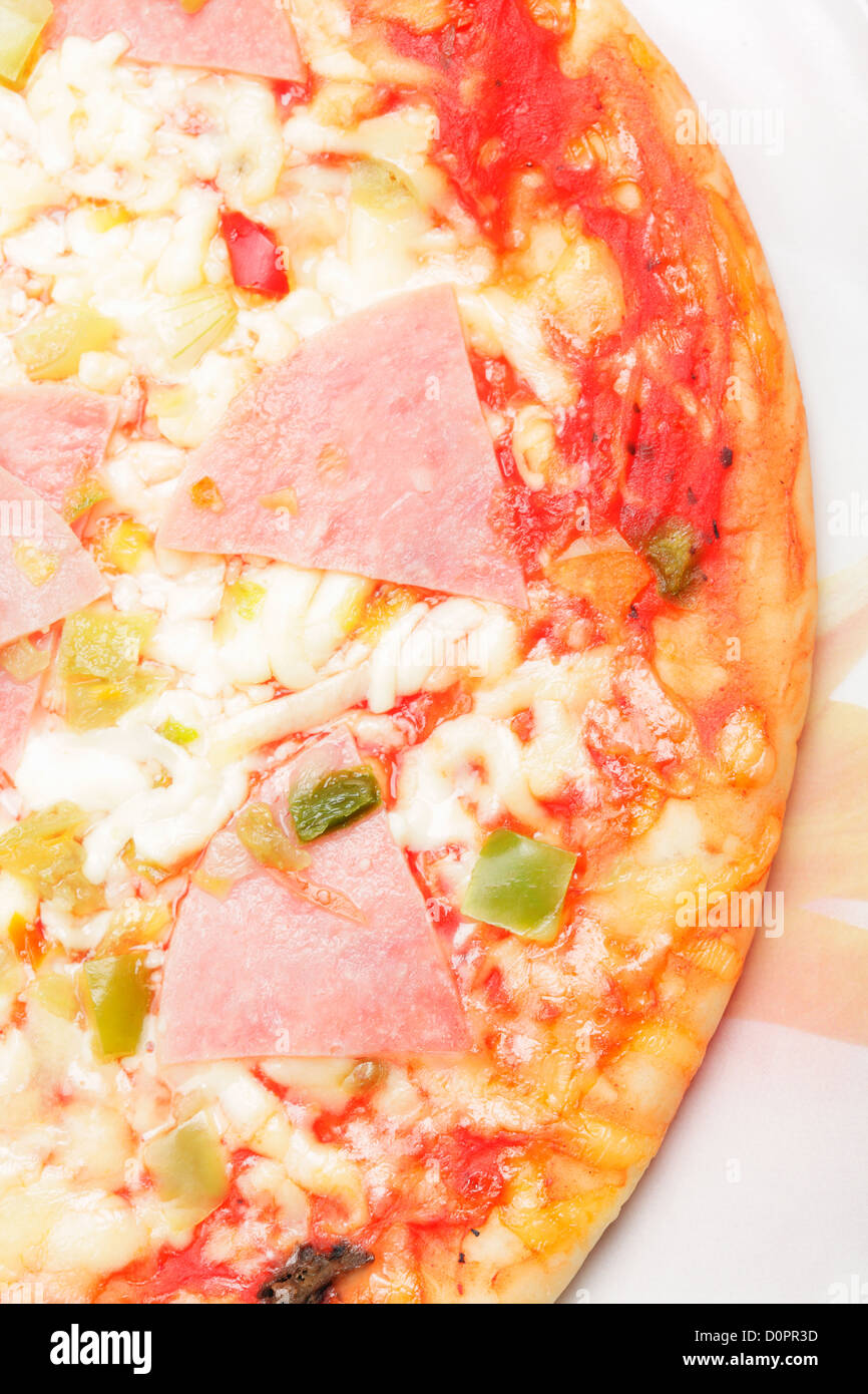 Ham pizza on plate closeup Stock Photo - Alamy
