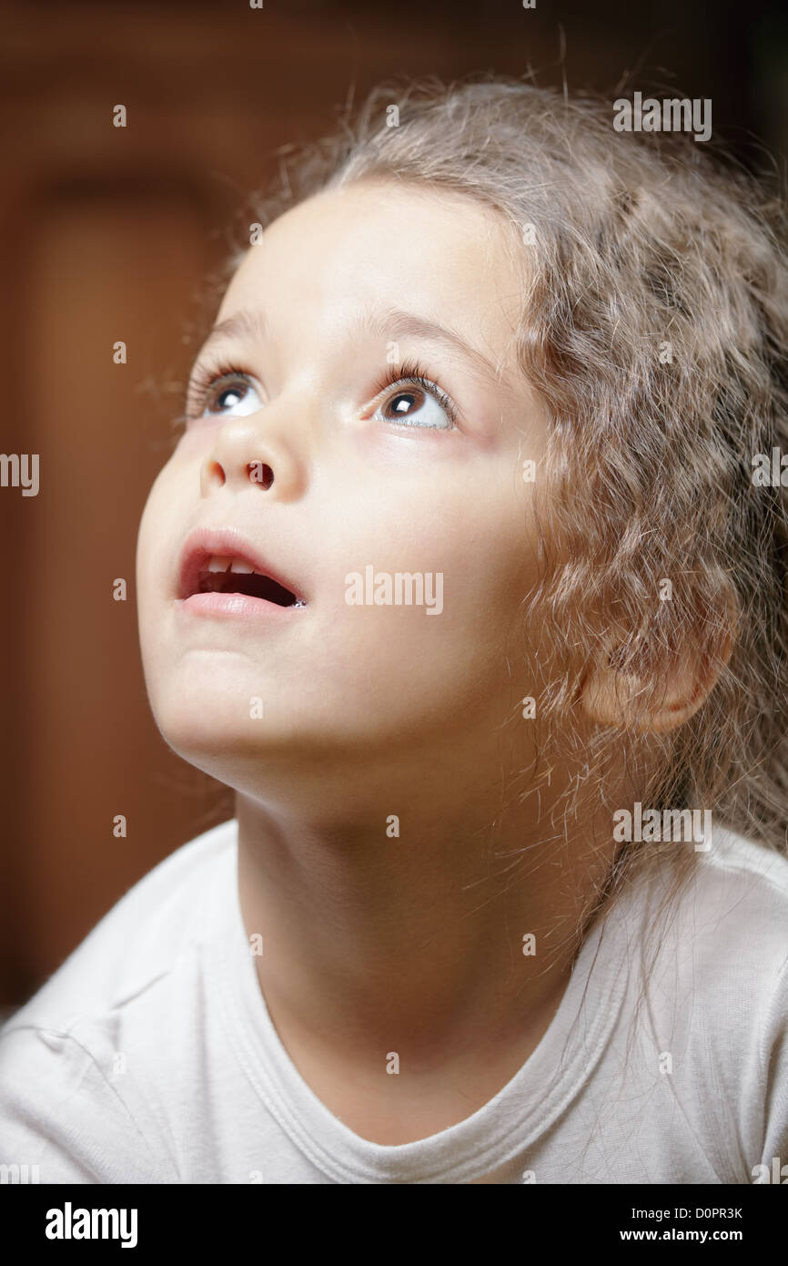 Cute girl looking up Stock Photo - Alamy