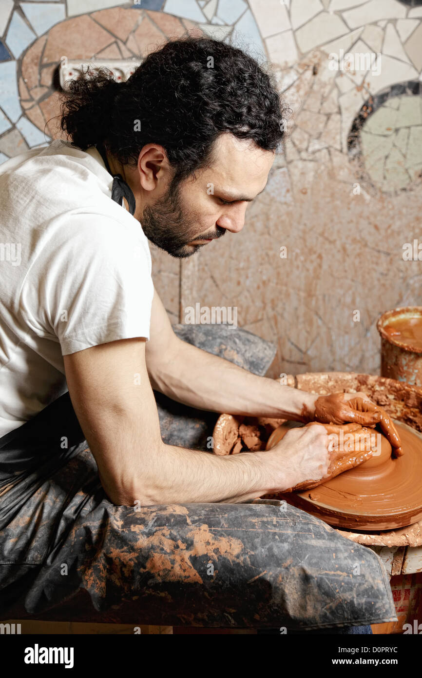Potter at work sideview Stock Photo - Alamy