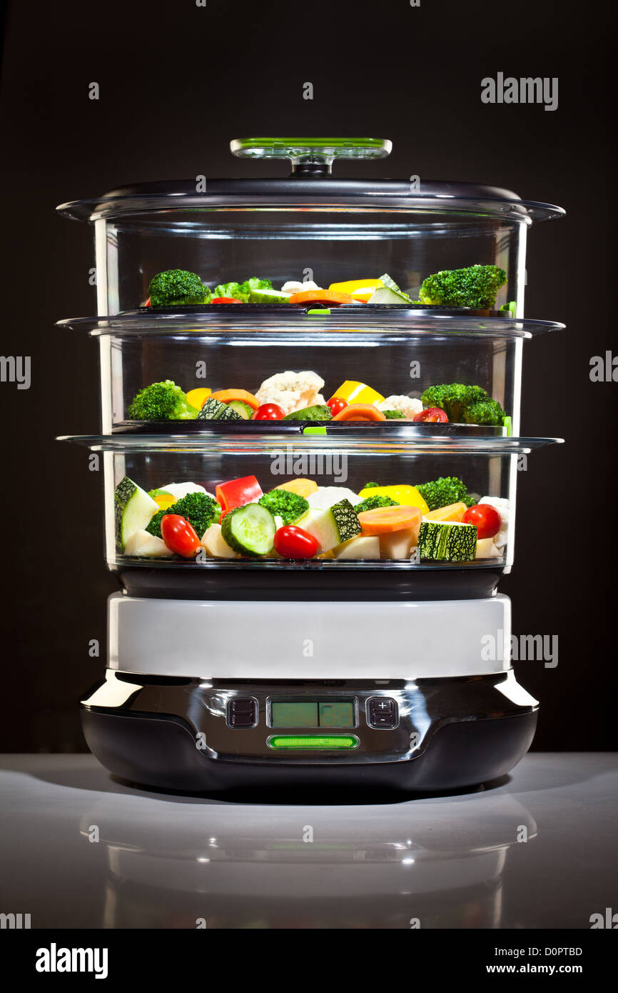Healthy cooking, steam cooker with vegetables Stock Photo - Alamy