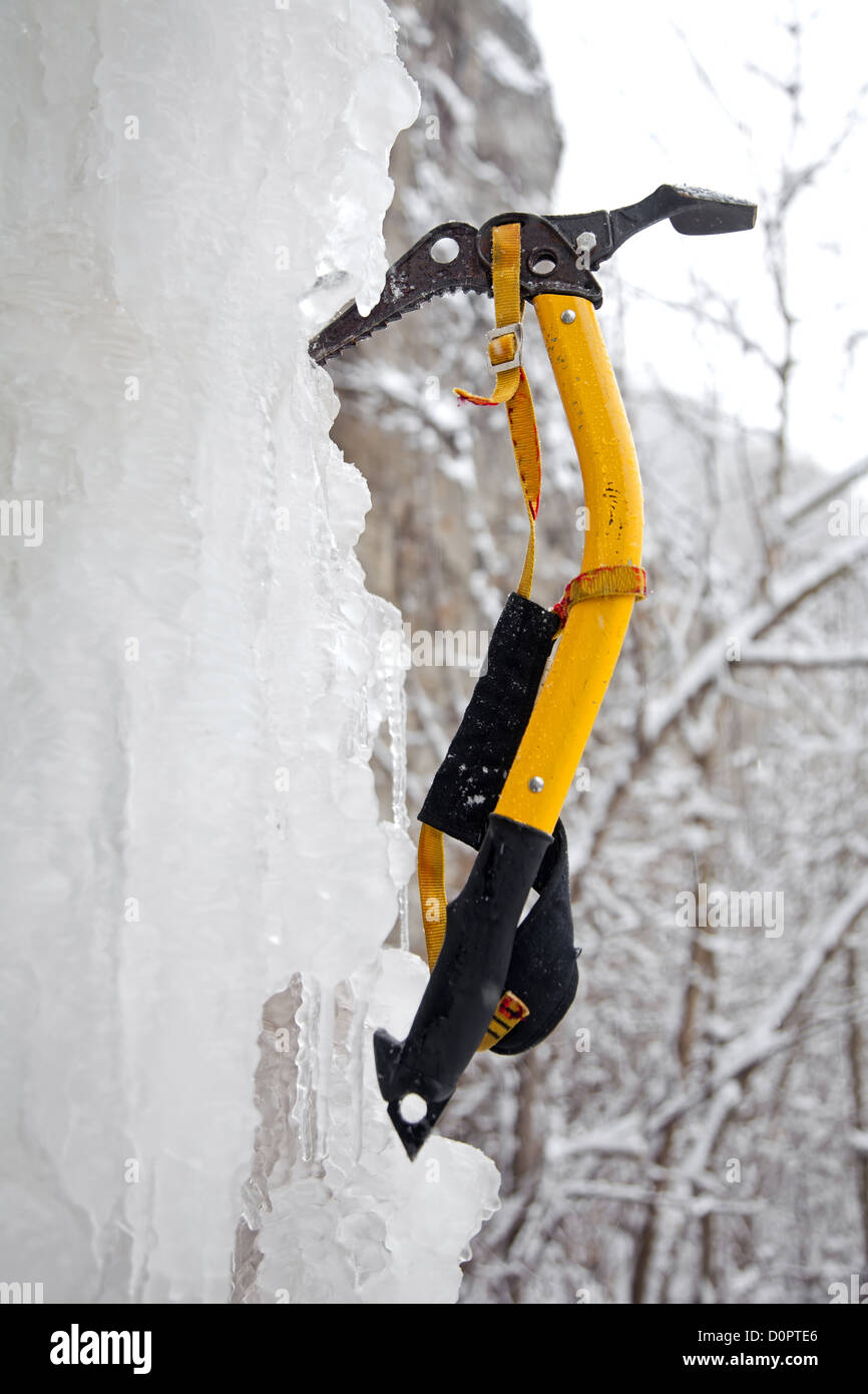 Climbing ice ax in the white ice Stock Photo - Alamy