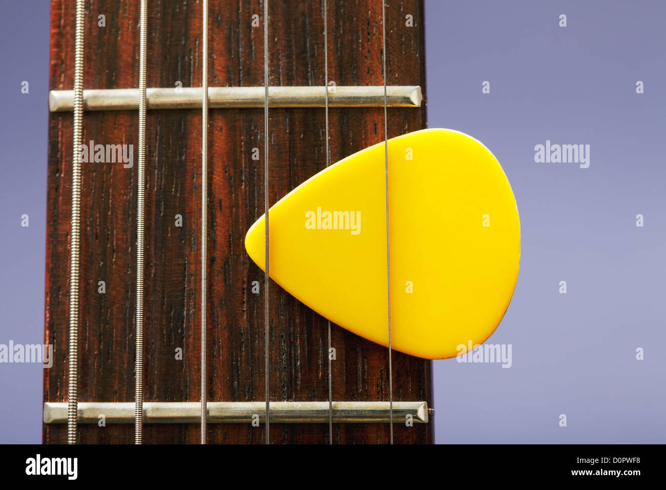 Plectrum between strings Stock Photo - Alamy