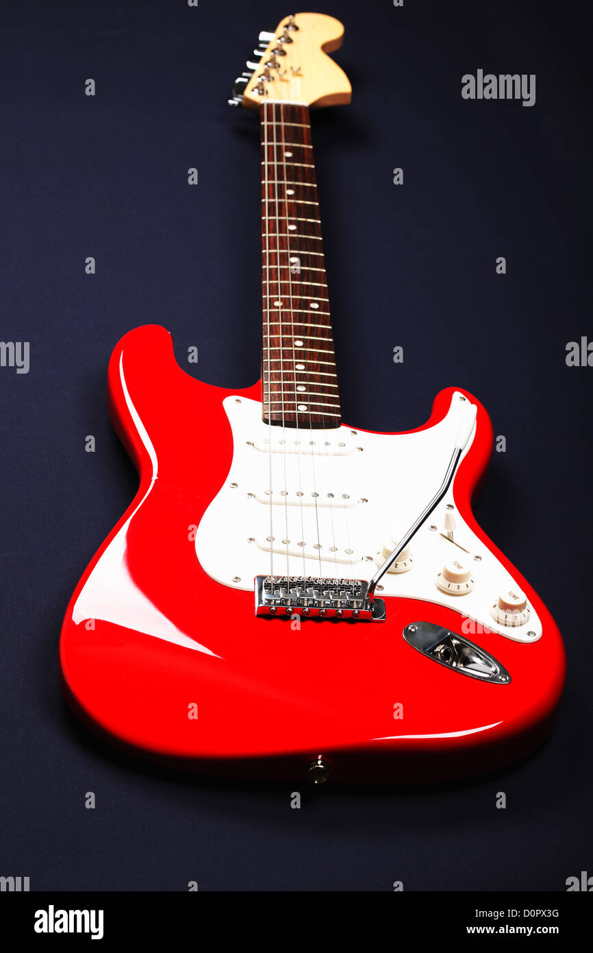 Red and white guitar over blue Stock Photo - Alamy