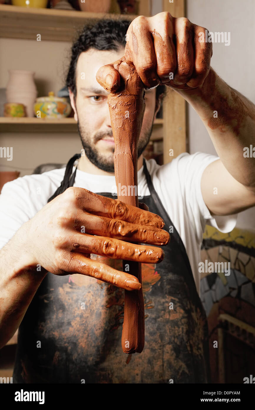 Craftsman stretching clay Stock Photo - Alamy