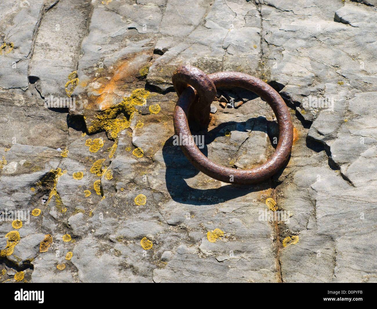 Rusty iron ring bolted in rock ready for rope from anchoring boats in ...