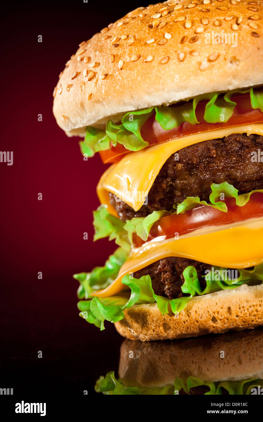 Tasty and appetizing hamburger on a darkly red Stock Photo - Alamy