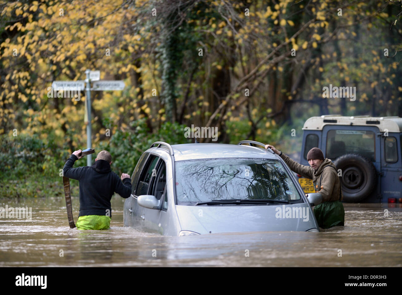 A car stuck at Damery in Gloucestershire where the Little Avon River ...