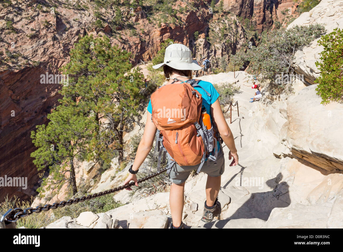 Young woman holding a safety chain while descending along an Angel's ...
