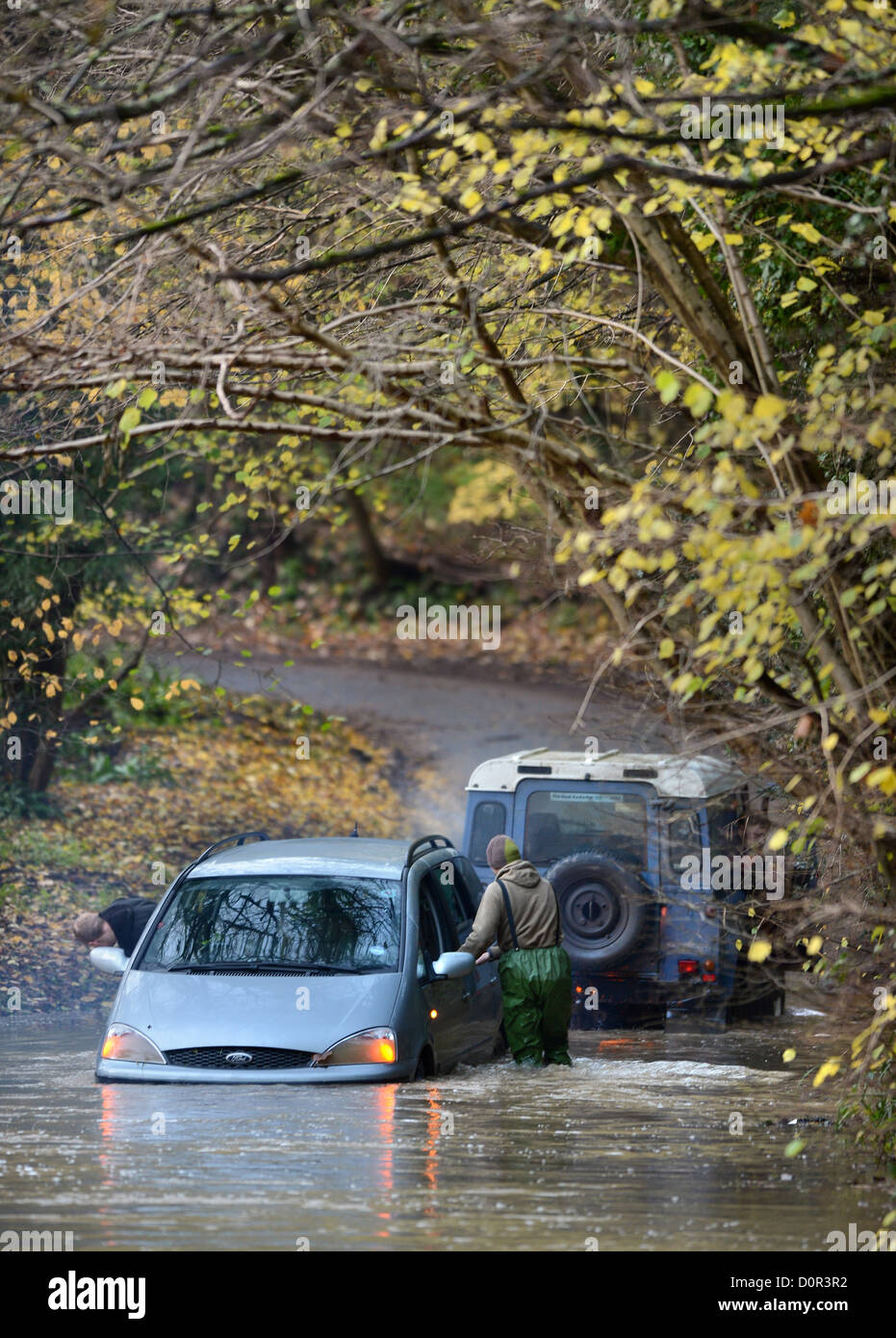 A car stuck at Damery in Gloucestershire where the Little Avon River ...