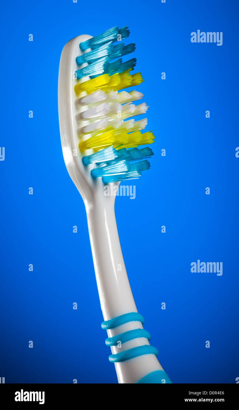 toothbrush on a dark blue background Stock Photo - Alamy