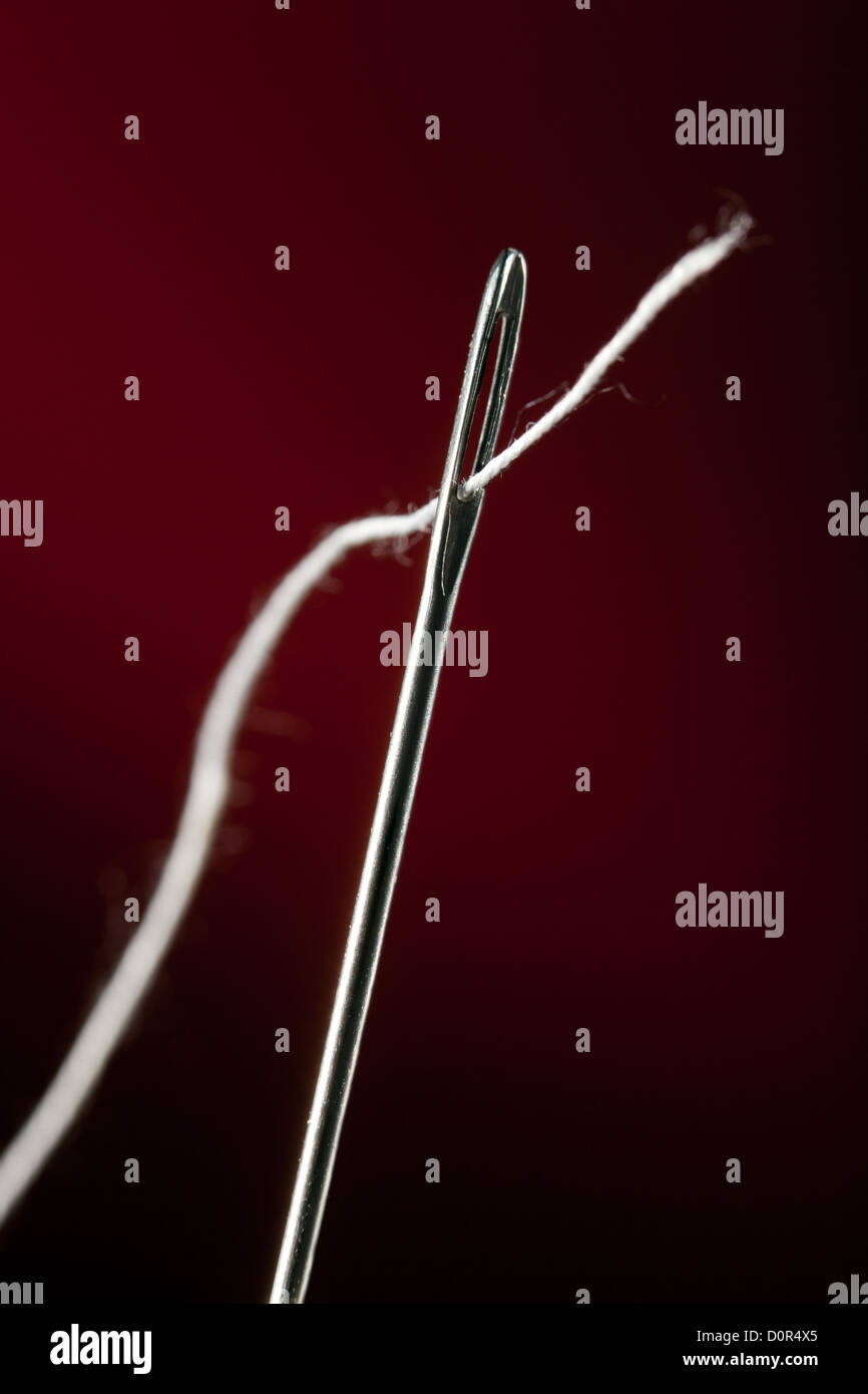 Needle with thread Stock Photo - Alamy