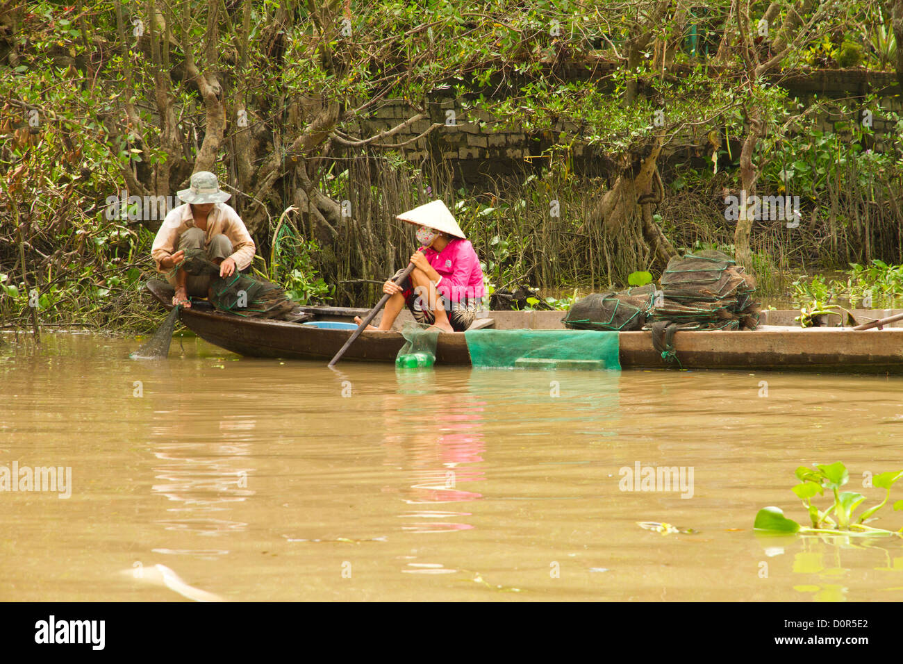 Fishing in a canal off the Mekong Delta in Vietnam Stock Photo - Alamy