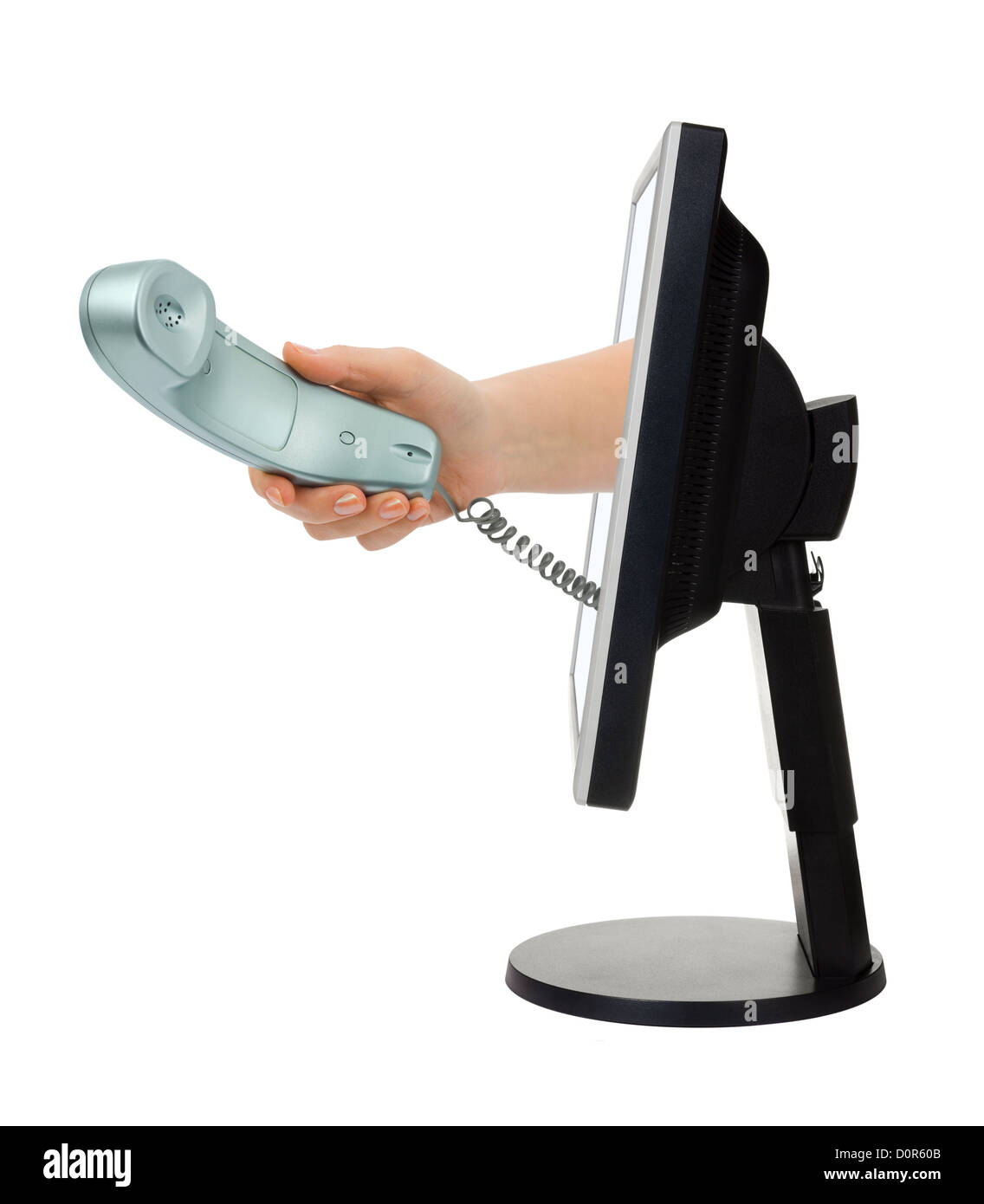 Computer screen and hand with phone Stock Photo - Alamy