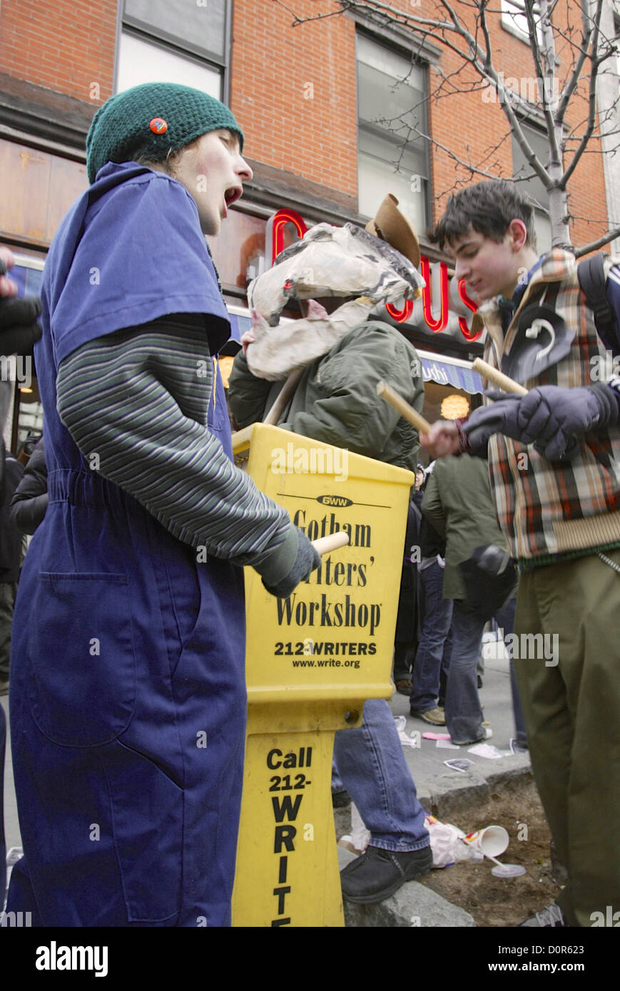 Protesters drum on a newspaper box during a protest of the buildup for ...