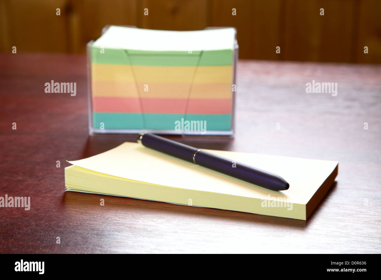 Pen and the block of stickers Stock Photo - Alamy