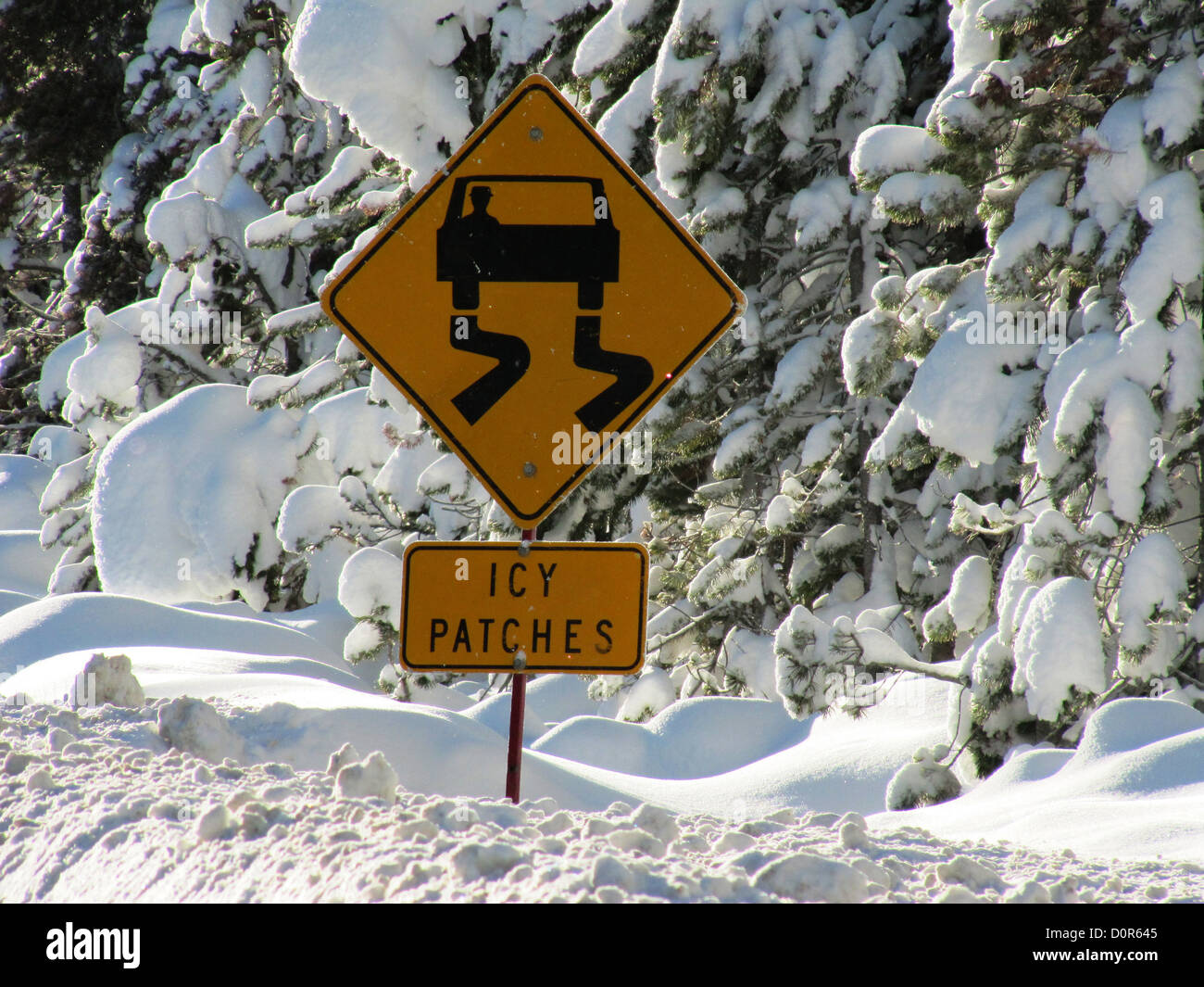 An ironic yellow snow covered icy patch warning sign Stock Photo - Alamy
