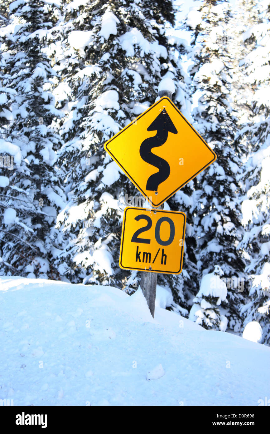 Yellow sign warning of bends in the road Stock Photo - Alamy