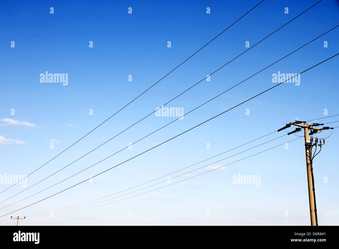 Power lines in front of a blue sky Stock Photo - Alamy