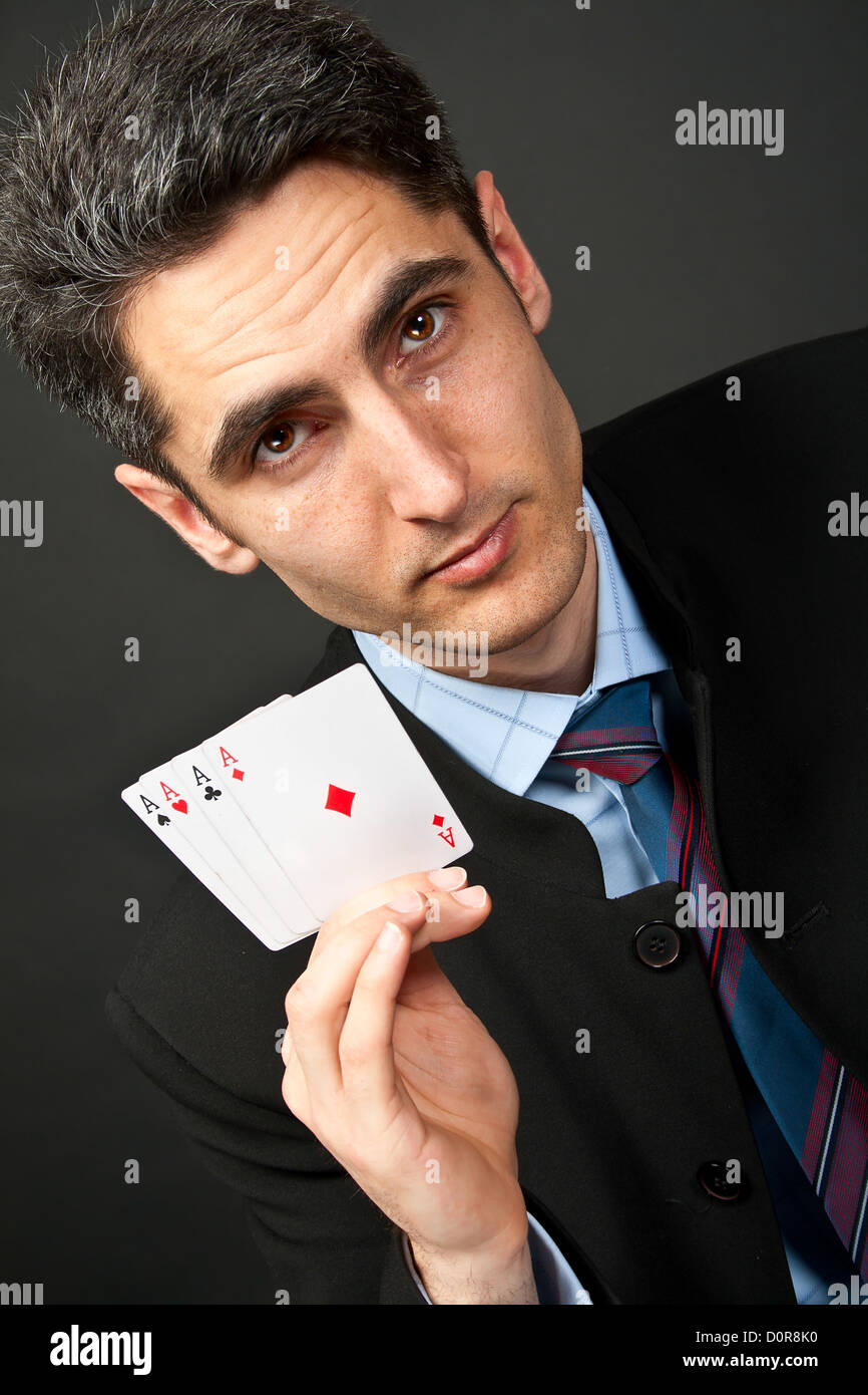 Young lucky gambler with cards Stock Photo - Alamy