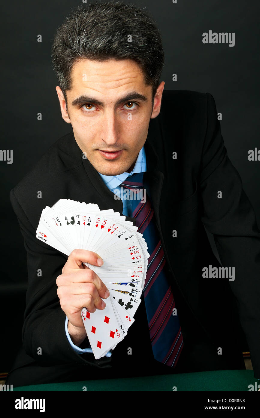 Young lucky gambler with cards Stock Photo - Alamy