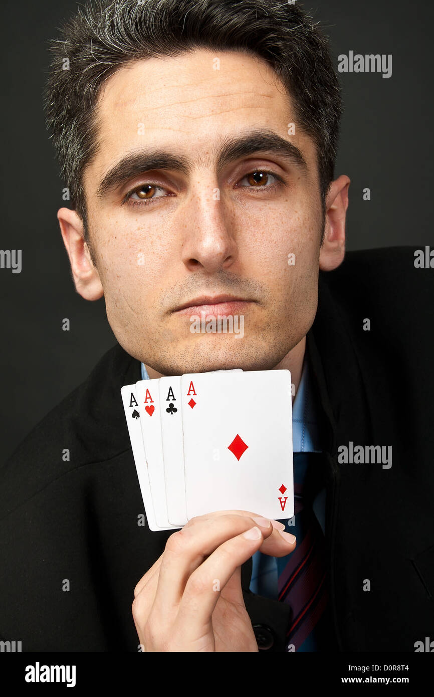 Young lucky gambler with cards Stock Photo - Alamy