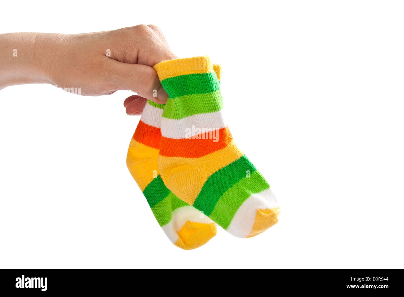 Two baby socks in woman's hand Stock Photo - Alamy