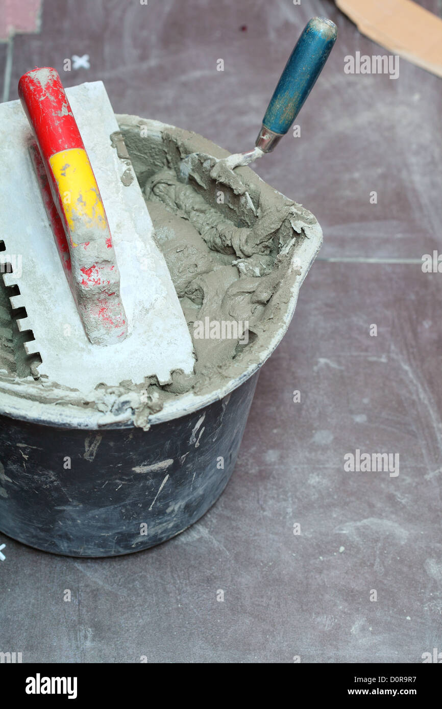 mortar on wall construction notched trowel work tools Stock Photo - Alamy