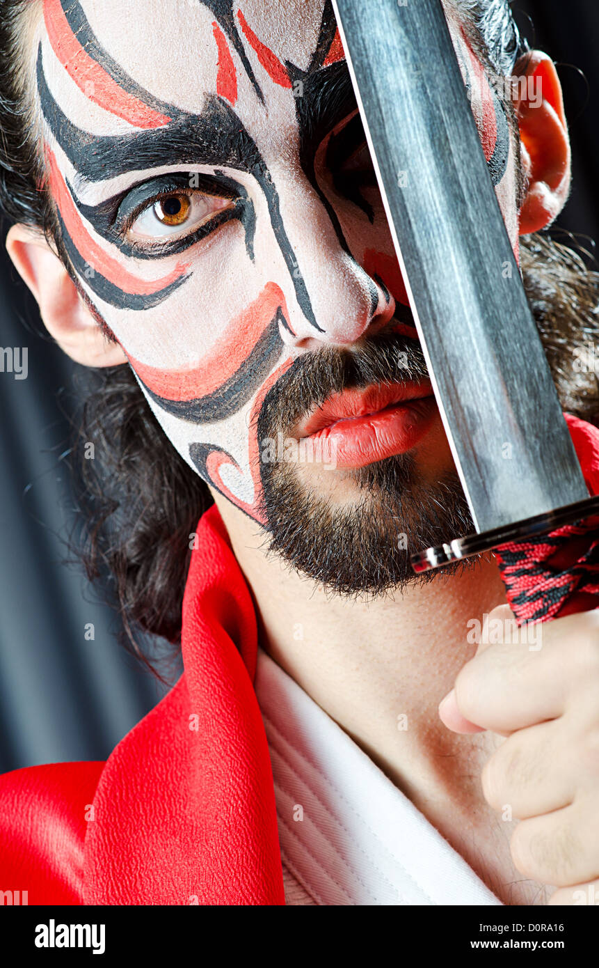 Man with face mask and sword Stock Photo - Alamy