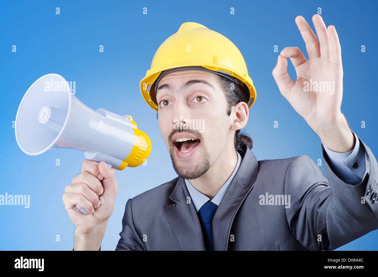 Construction worker shouting via loudspeaker Stock Photo - Alamy