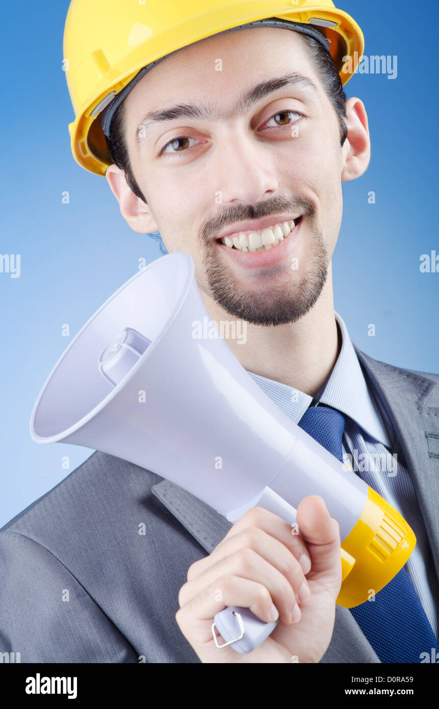 Construction worker shouting via loudspeaker Stock Photo - Alamy