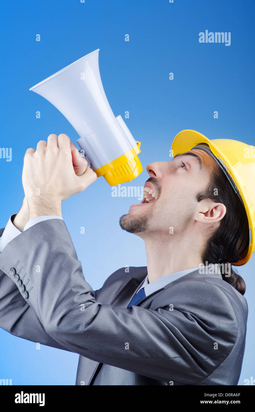 Construction worker shouting via loudspeaker Stock Photo - Alamy