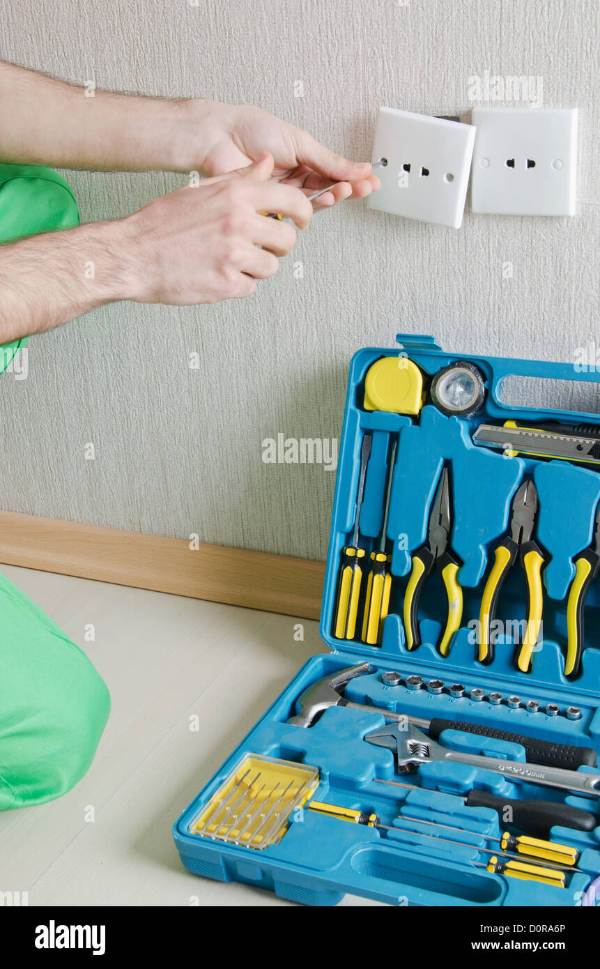 Electrician repairman working in the house Stock Photo - Alamy