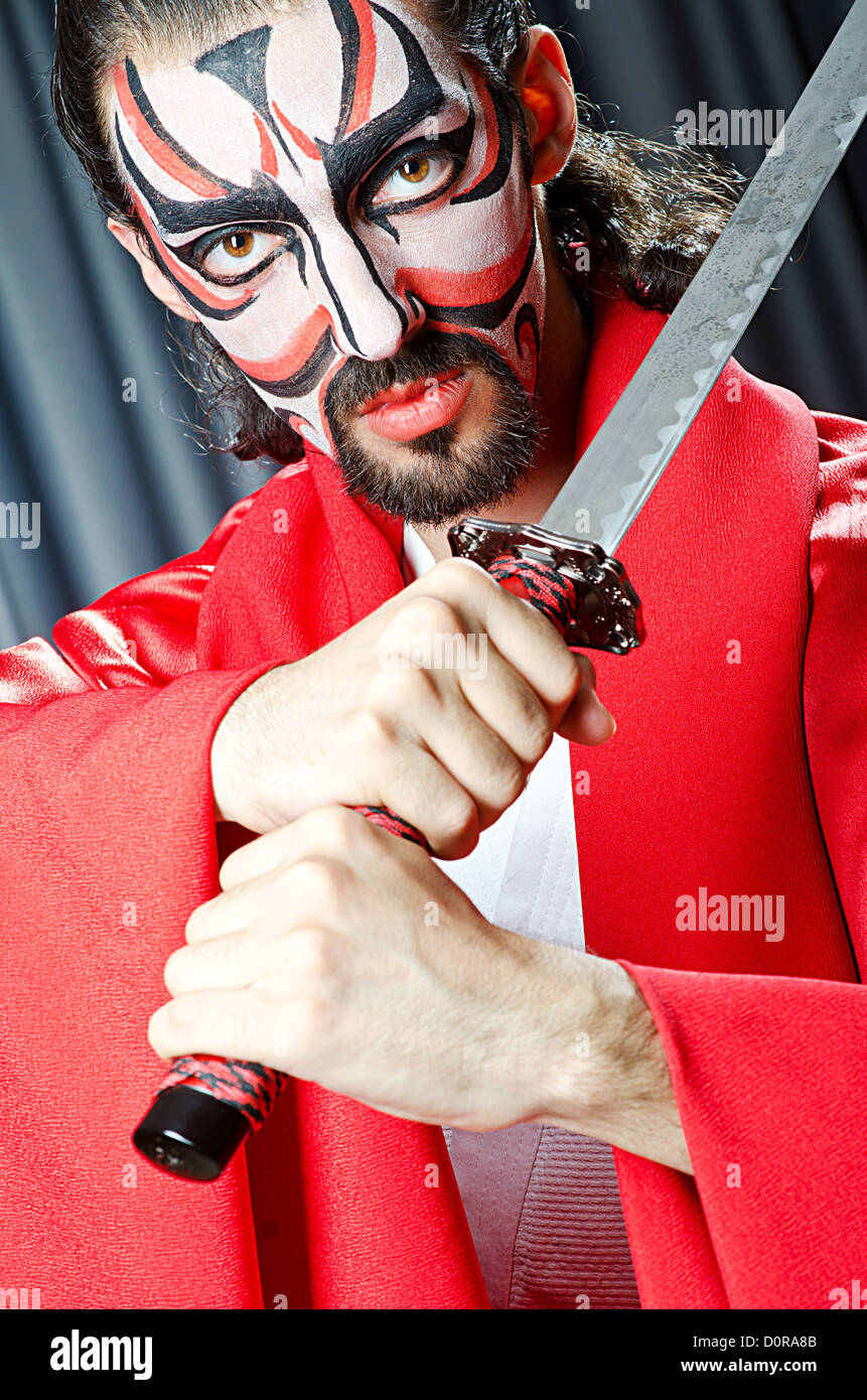 Man with face mask and sword Stock Photo - Alamy