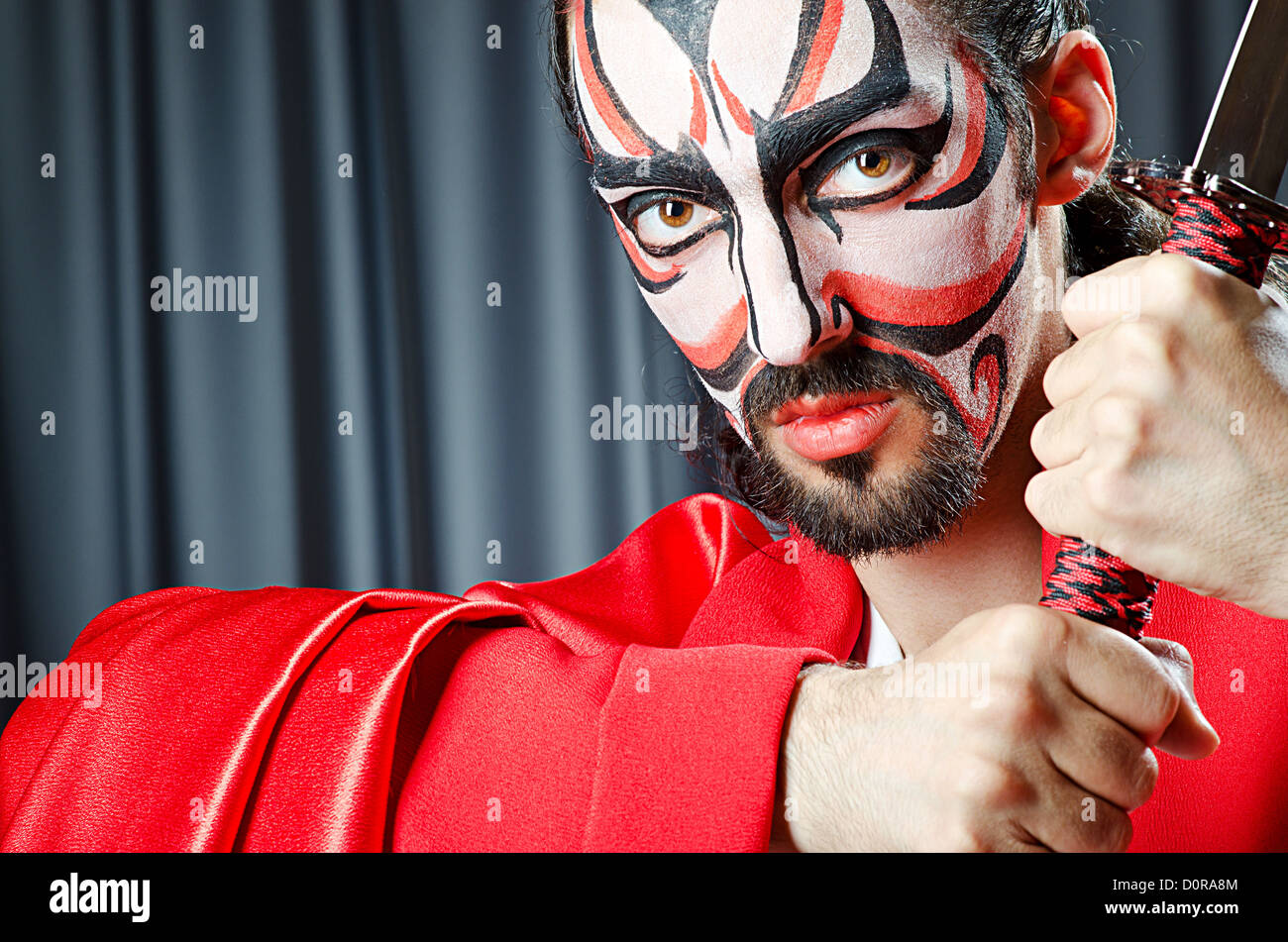 Man with face mask and sword Stock Photo - Alamy