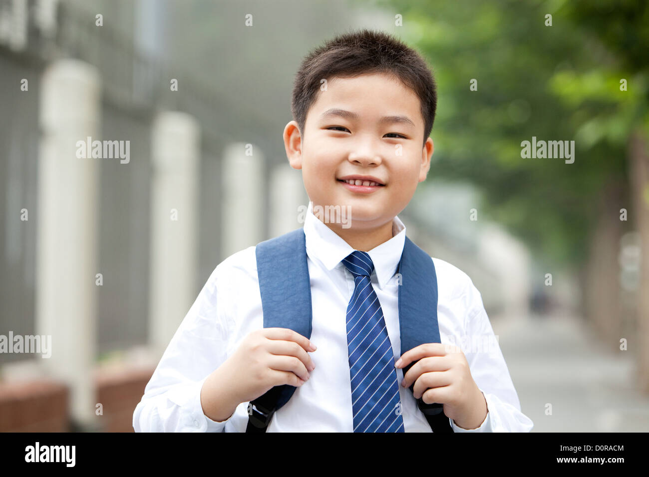 Portrait of cute schoolboy in uniform on the way to school Stock Photo ...