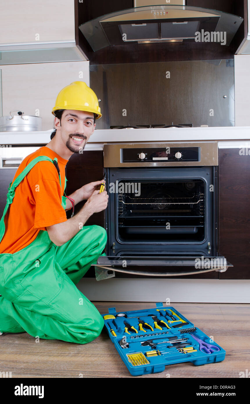 Repairman assembling the furniture at kitchen Stock Photo - Alamy