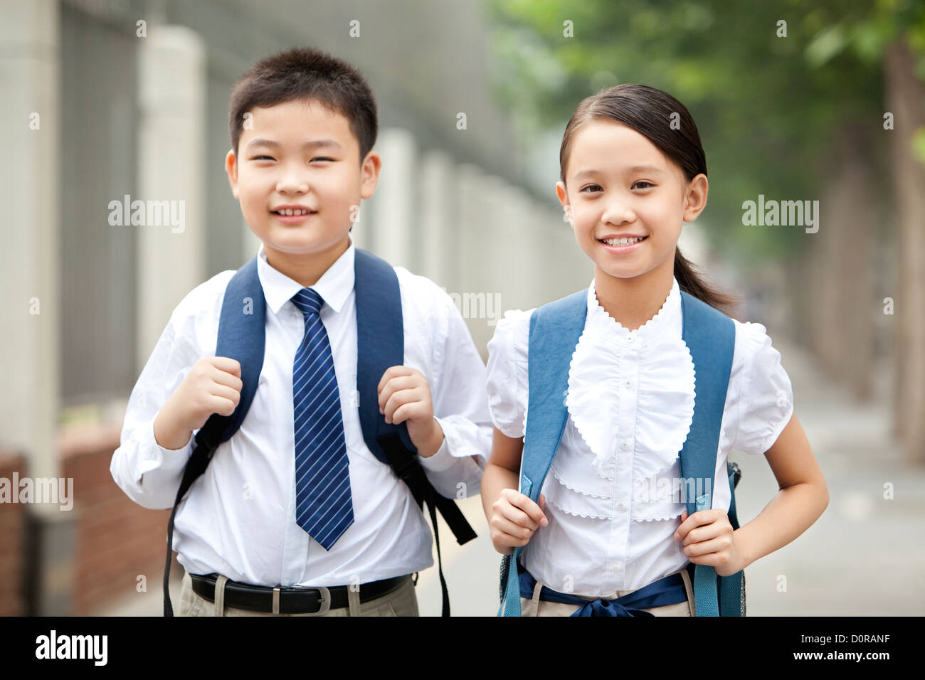 Cute schoolchildren in uniform on the way to school Stock Photo - Alamy