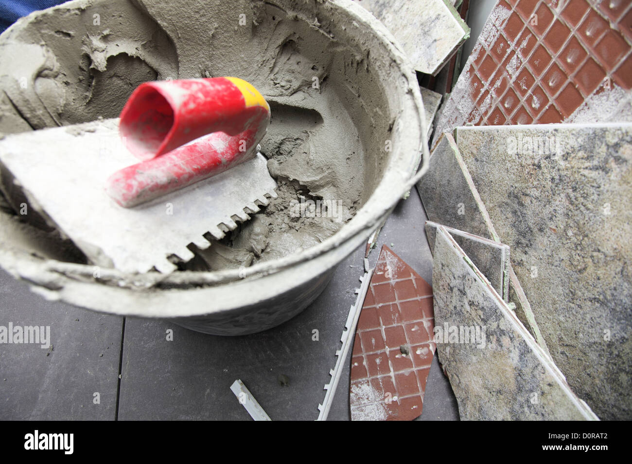 mortar on wall construction notched trowel work tools Stock Photo - Alamy