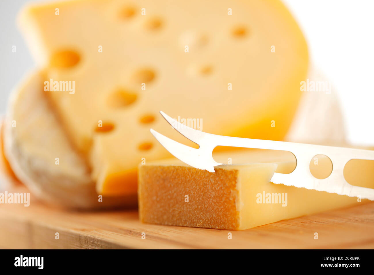 cheese with a cheese knife Stock Photo - Alamy