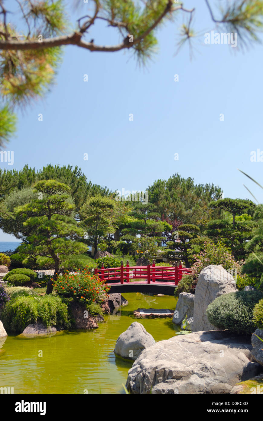 Japanese red bridge in zen garden Stock Photo - Alamy