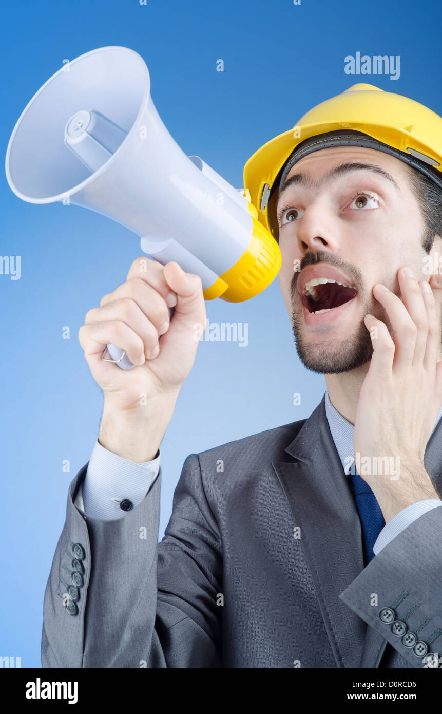 Construction worker shouting via loudspeaker Stock Photo - Alamy