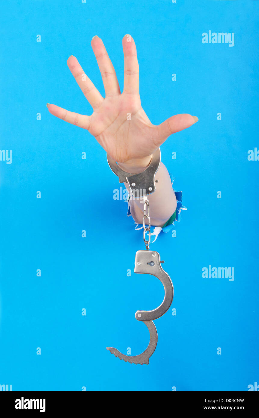 Hand with handcuffs out of paper Stock Photo - Alamy